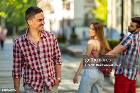 Disloyal Man Walking With His Girlfriend Photos And Premium High Res