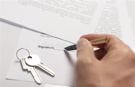Businessman Signing Contract With Keys On Table Real Estate Agreement