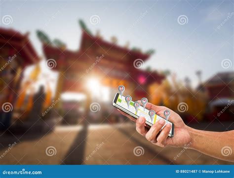 Man S Hand Holding Mobile Phone With Map And Navigation Symbol On Screen On Blurred City