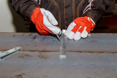 The Worker Makes A Mark On A Metal Surface By Means Of Measuring Square