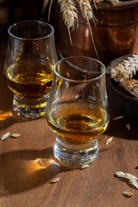 Small Tasting Glasses With Aged Scotch Whisky On Old Dark Wooden