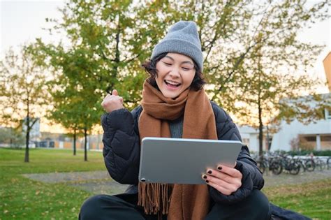 Premium Photo Portrait Of Happy Asian Girl Sits On Bench Looks At