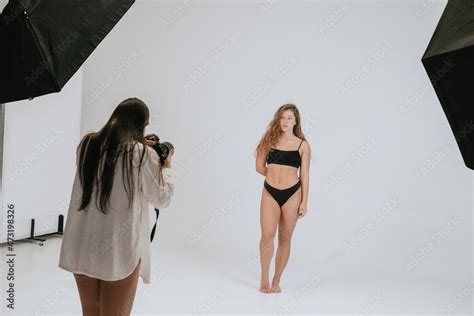 Professional Male Photographer Taking Pictures Of Woman Model Stock
