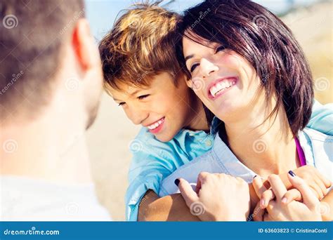 Mother Cuddles Her Son While Father Watches Them Moved Stock Image Image Of Embrace Healthy