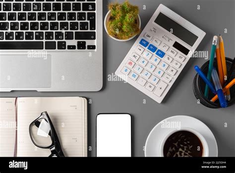 Notepad Is On Top Of Office Desk Table With Laptop And Supplies Stock