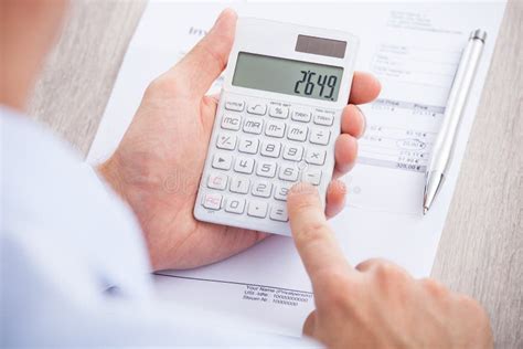 Businessman Calculating Invoice At Desk Stock Photo Image Of Banking