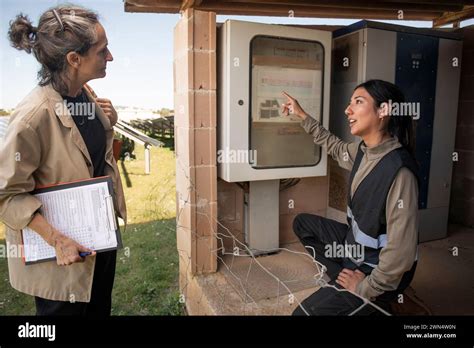 Female Engineer Explaining Control Panel To Senior Entrepreneur During Visit At Power Station
