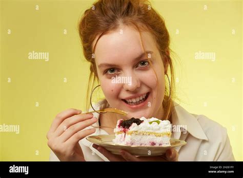 Fun Pretty Curly Red Hair Girl With Sweet Dessert On Yellow Background Lick Lips Stock Photo Alamy