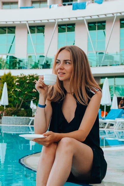 Premium Photo Portrait Of Young Woman Sitting In Swimming Pool