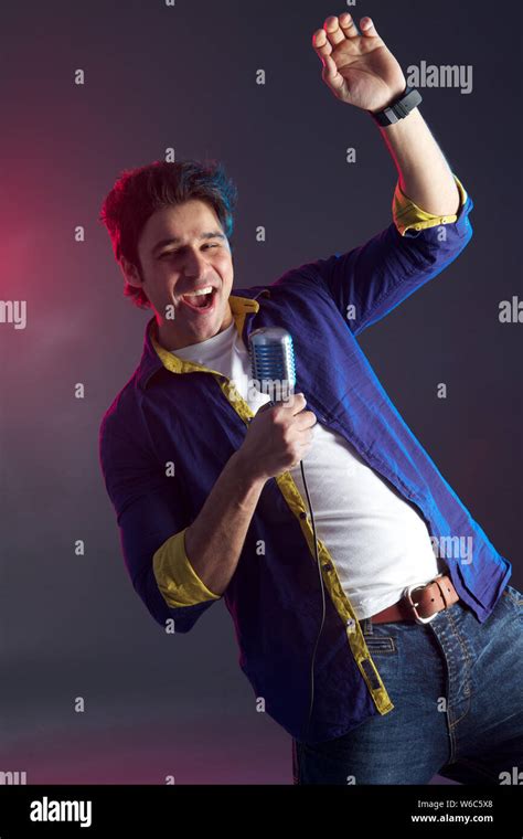 Man Singing Into Microphone Stock Photo Alamy