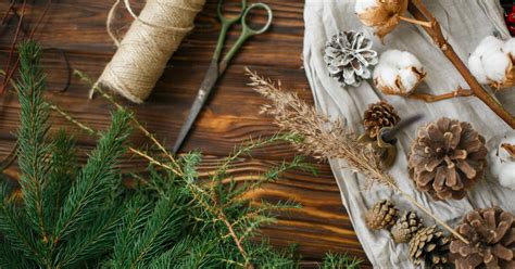 집에서 소박한 크리스마스 화환을 만들기 위한 크리스마스 나무 가지와 장식 천연 전나무 가지 솔방울 허브 꼬기 면화 나무 배경에 가위 상위 뷰 사진