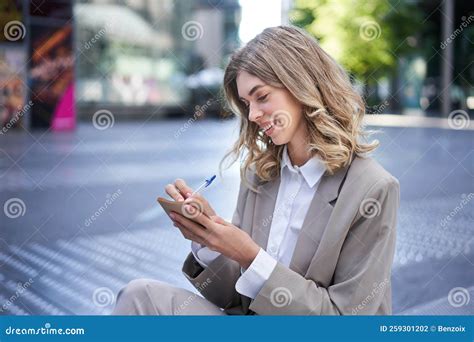 Young Businesswoman Preparing For Speech Interview In Company Writing