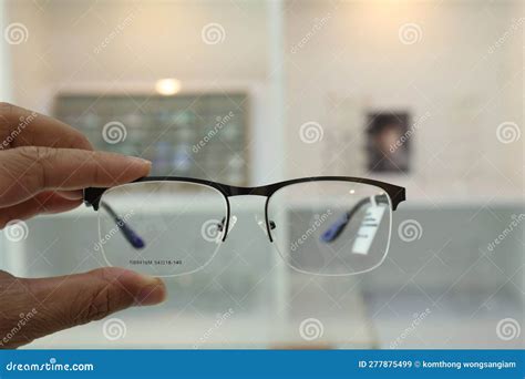 Hand Holding Glasses In Eyeglasses Shop Glasses In Female Hand Stock