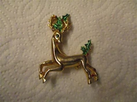 Prancing Gold Tone Reindeer Pin W Glass Mistletoe On Its Tail Between