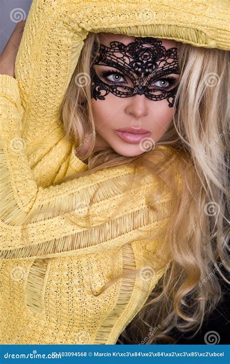 Beautiful Sensual Blonde Woman With Carnival Mask On Her Face Stands On