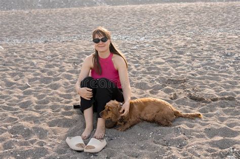 Beautiful Young Girl And Her Cocker Spaniel Dog Having Fun On The Beach