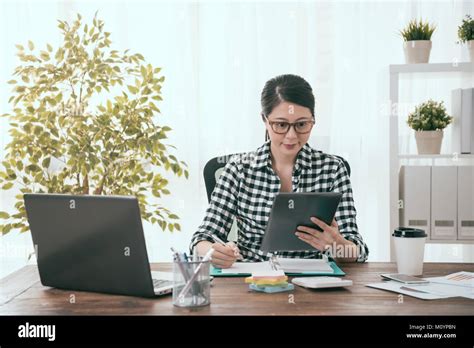 Professional Young Business Soho Woman Using Mobile Pad Computer Browsing Work Document