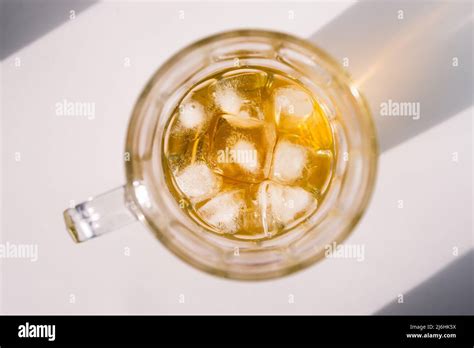 Golden Brown Or Amber Liquor In Stein Glass With Ice On White