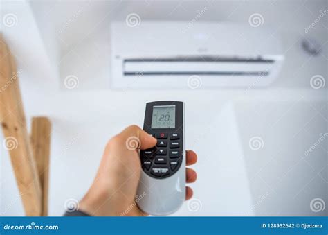 Man Adjusting And Regulating Temperature On Home Air Conditioner Royalty Free Stock Image