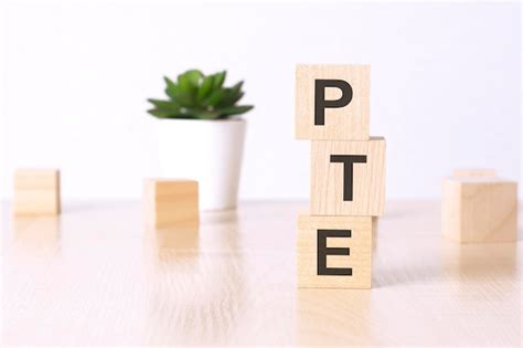 Premium Photo Pte Pearson Tests Of English Text On Wooden Cubes On A