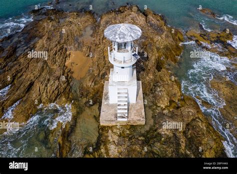 Drone View Of A Small Offshore Lighthouse Located On A Small Rocky