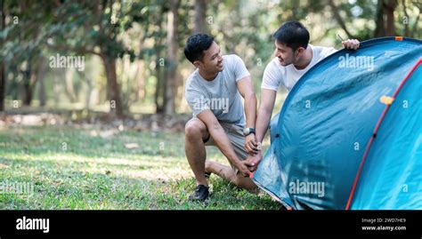Lgbtqia Gay Couple Camping Together In Woods For Holidays And Helping