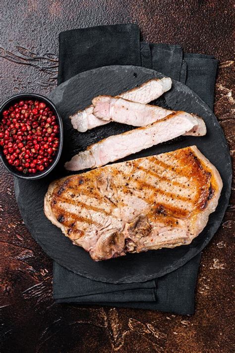 Roast Bbq Pork Chop Or T Bone Meat Steak Sliced On A Board Dark