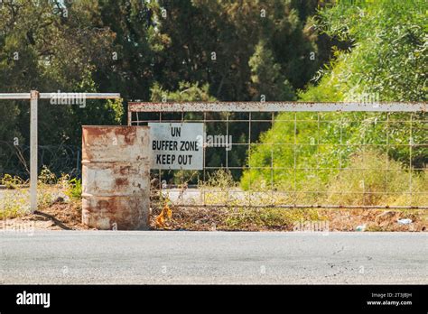 A Sign Reads Un Buffer Zone Keep Out At A Border Crossing Between