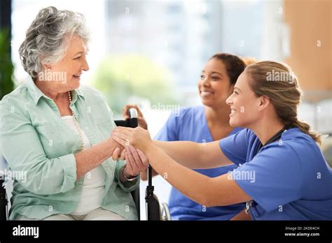 Were Dedicated To Your Health Two Attractive Female Nurses Talking