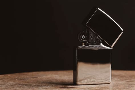 Premium Photo Closeup Of A Lighter On A Wood Table With Black Bacground