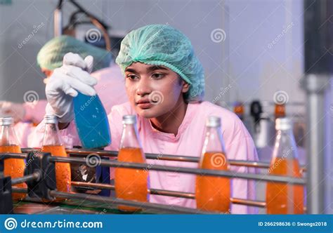 Product Quality Control Staff At The Fruit Juice Production Line