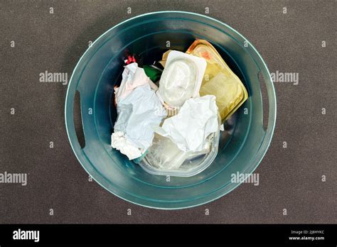Plastic Trash Can Being Filled With Household Garbage And Food