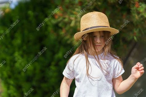 Little Cute Smiling Girl With Long Hair Without Tooth Wearing Straw Hat