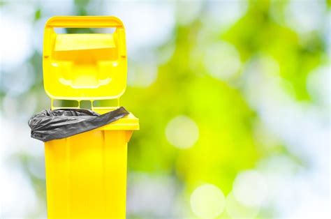 Premium Photo Yellow Garbage Bins On Green Nature Background