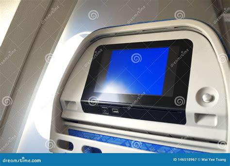 Airplane Monitor Behind Passenger Seat With Sun Light Through From The