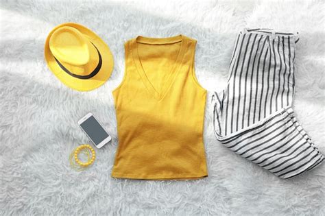 Premium Photo Stylish Set Of Female Clothes On Soft Plaid