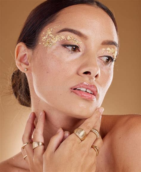 Face Cosmetics Facial Glitter And Woman With Luxury Gold Eyeshadow
