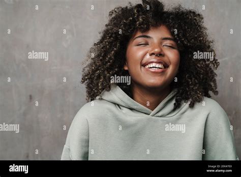 Joyful African American Woman Posing And Laughing At Camera Isolated