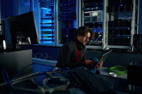 Premium Photo Male System Administrator Working In Server Room Using