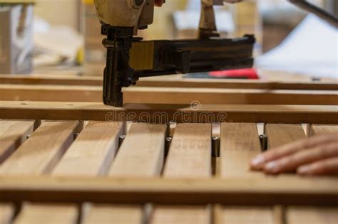 The Process Of Assembling A Wooden Structure Close Up Using A Construction Stapler Stock Image