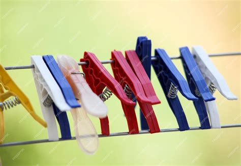 Premium Photo Plastic Clothes Pegs On The Clothes Dryer Background