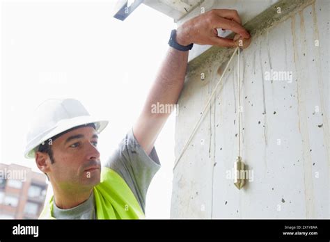 Worker With Protective Equipment Ppe Checking And Aligning Vertical