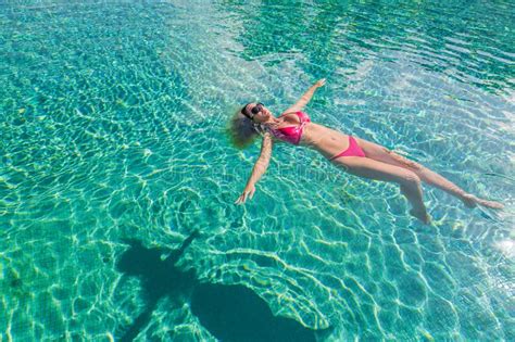 Woman In The Pool On The Beach With A Pink Bikini Enjoying Water Stock