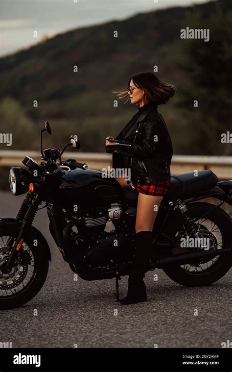 Portrait Of Confident Motorcyclist Woman In Mini Skirt Leather Jacket