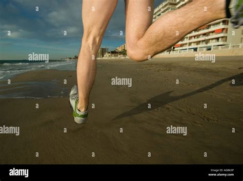 Close Up Of Male Runner S Feet On Beach Stock Photo Alamy