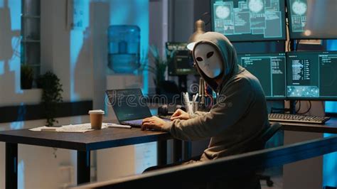 Cyber Impostor With Anonymous Mask Breaking Security System Stock Image