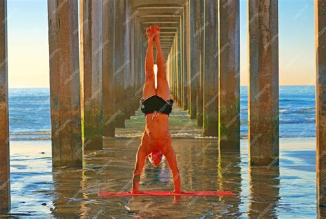 Premium Photo Shirtless Man Practicing Yoga Amidst Architectural