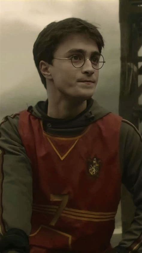 A Young Man Wearing Glasses And A Red Uniform