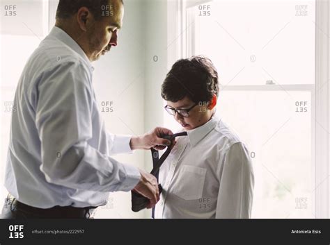 Father Helping Son Tie His Necktie Stock Photo OFFSET