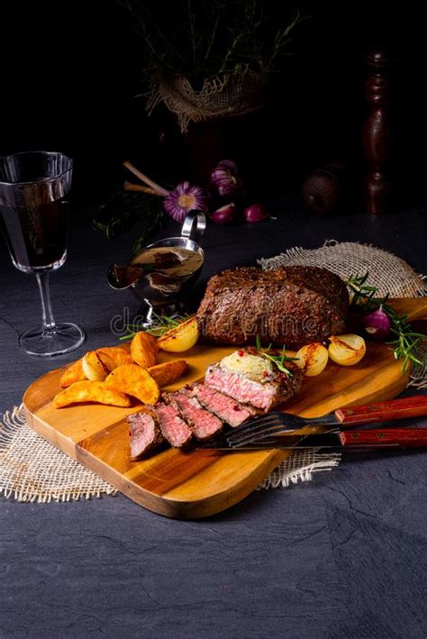 Rustic Medium Butter Beef Steak With Herbs And Potato Wedges Stock